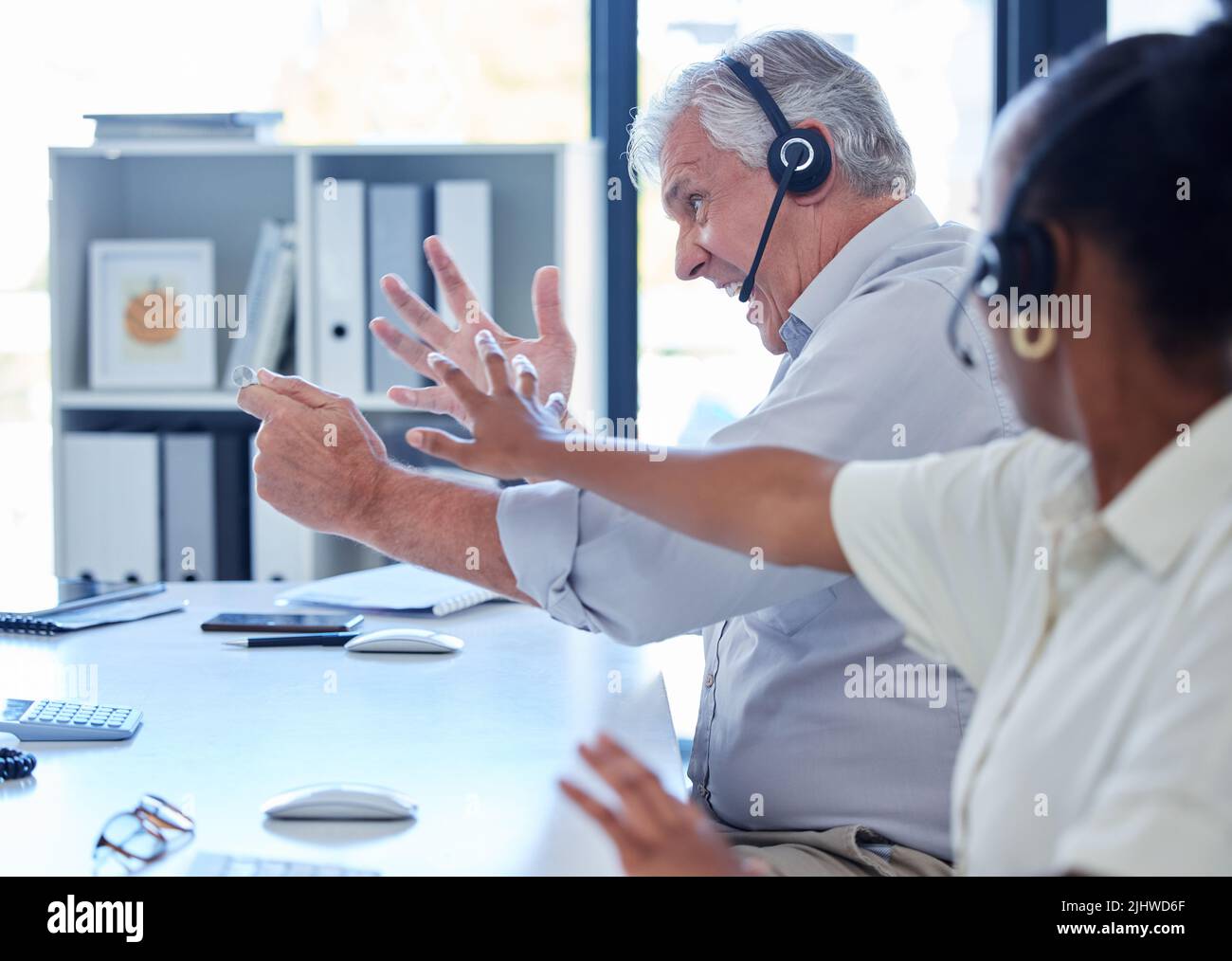 Losing his marbles over a technical glitch. a mature call centre agent ...