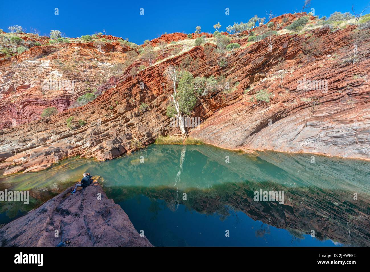 A couple are enjoying beautiful, tranquil, scenery of Hamersley gorge ...