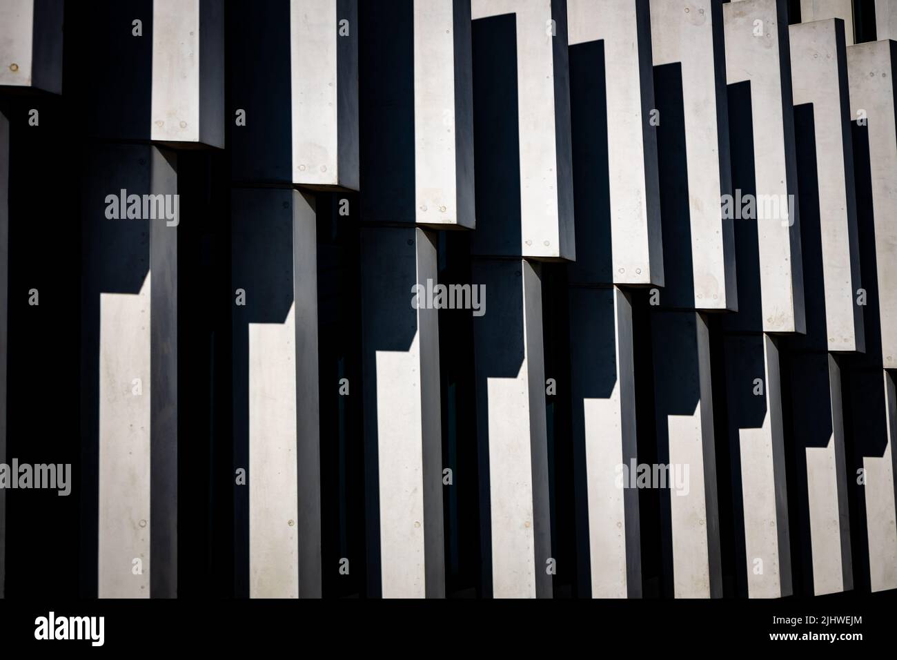 Repeating pattern of windows of a building. Optical effect by the shade ...