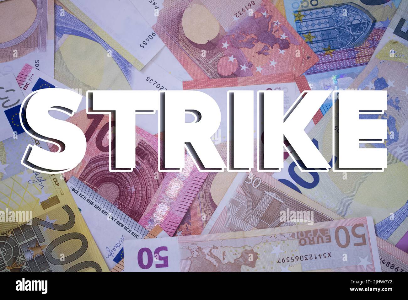 Strike word with money. Paper currency background with different ...