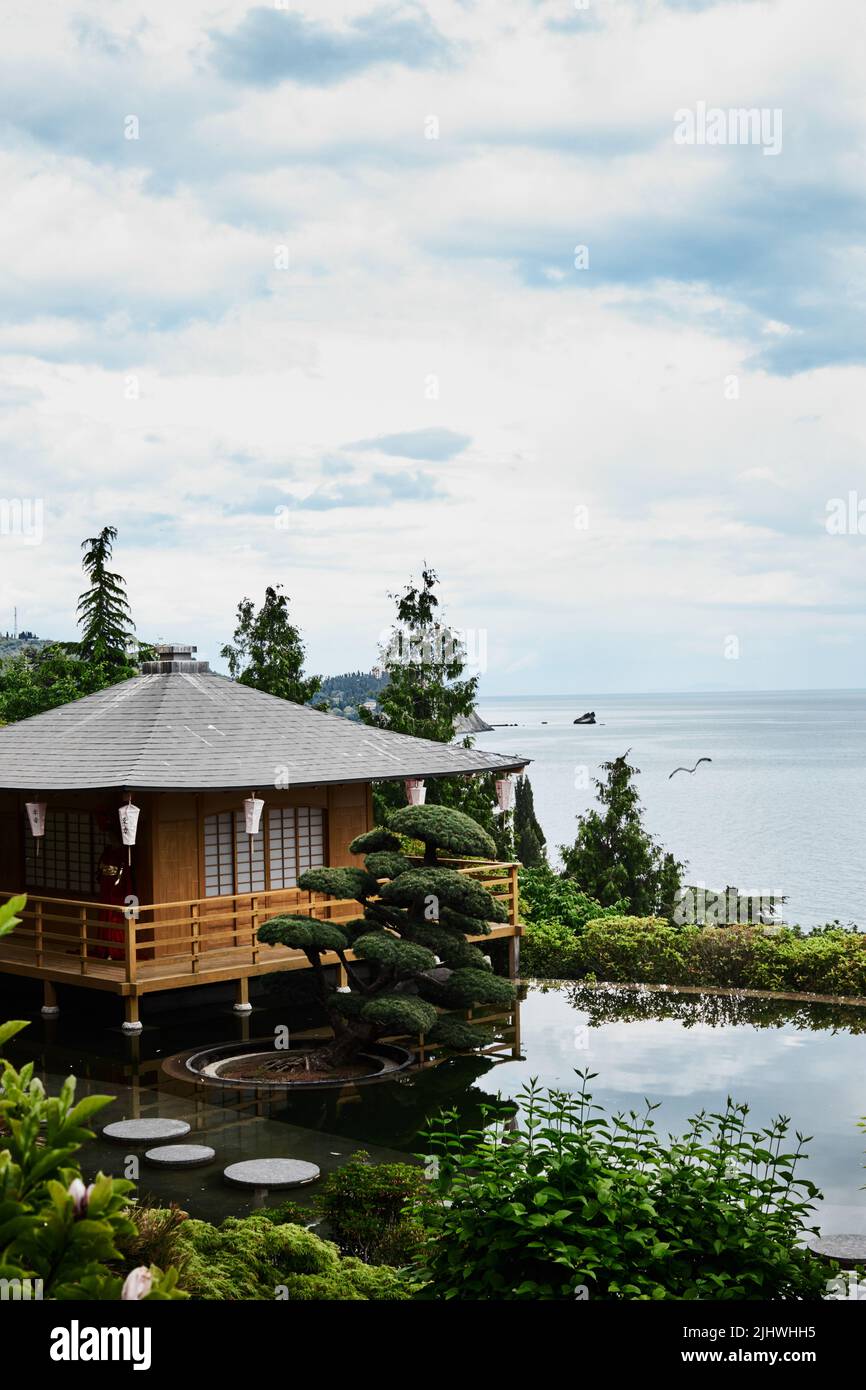Japanese-style house by the sea. View of the sea, rocks and forest ...