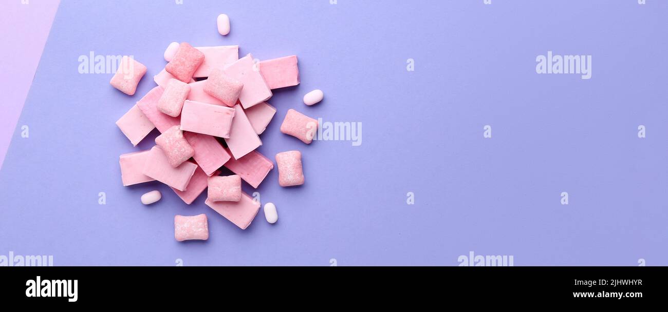 Tasty chewing gums on color background with space for text Stock Photo ...