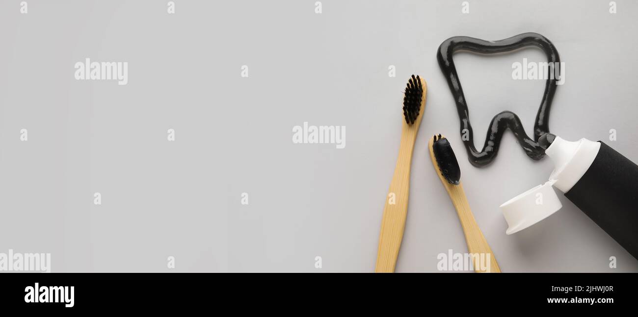 Tooth made of activated charcoal tooth paste and bamboo brushes on ...