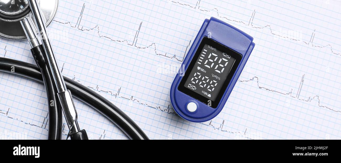 Pulse oximeter and stethoscope on cardiogram, top view Stock Photo - Alamy