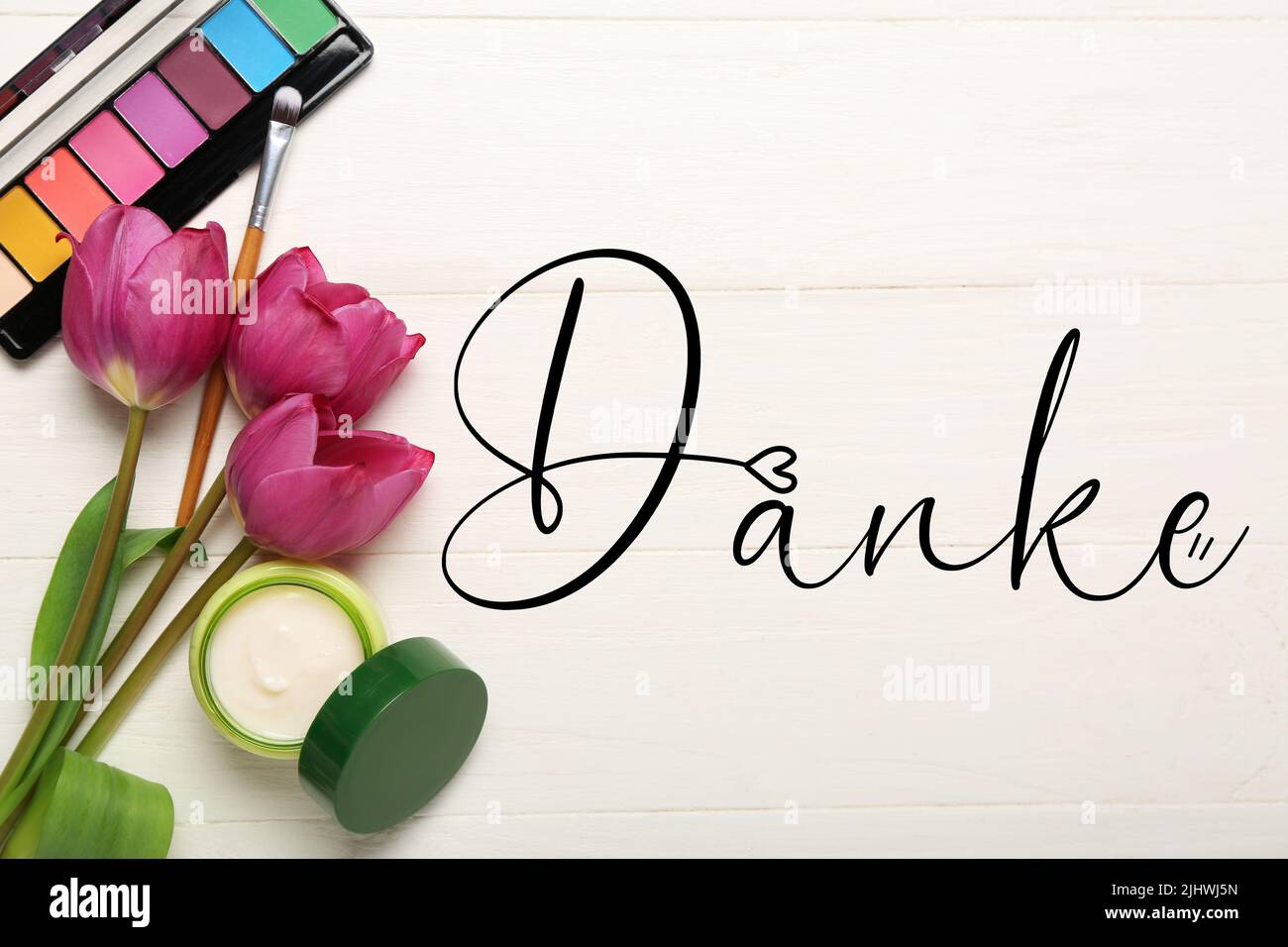 Decorative cosmetics, cream, flowers and word DANKE (German for Thanks ...