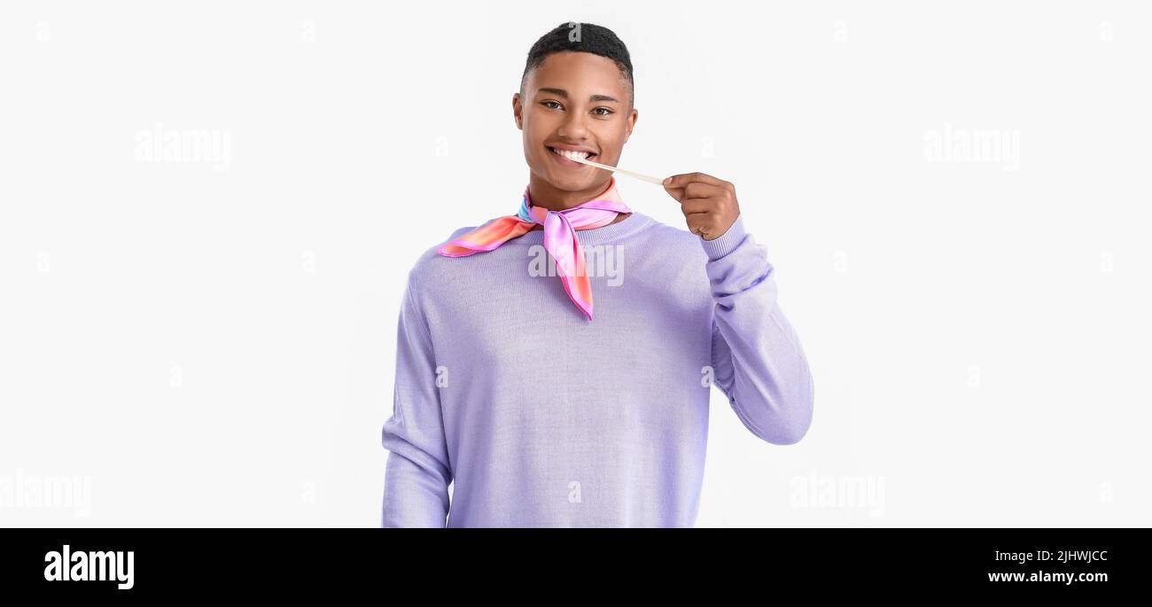 Young African-American guy with chewing gum on white background Stock ...