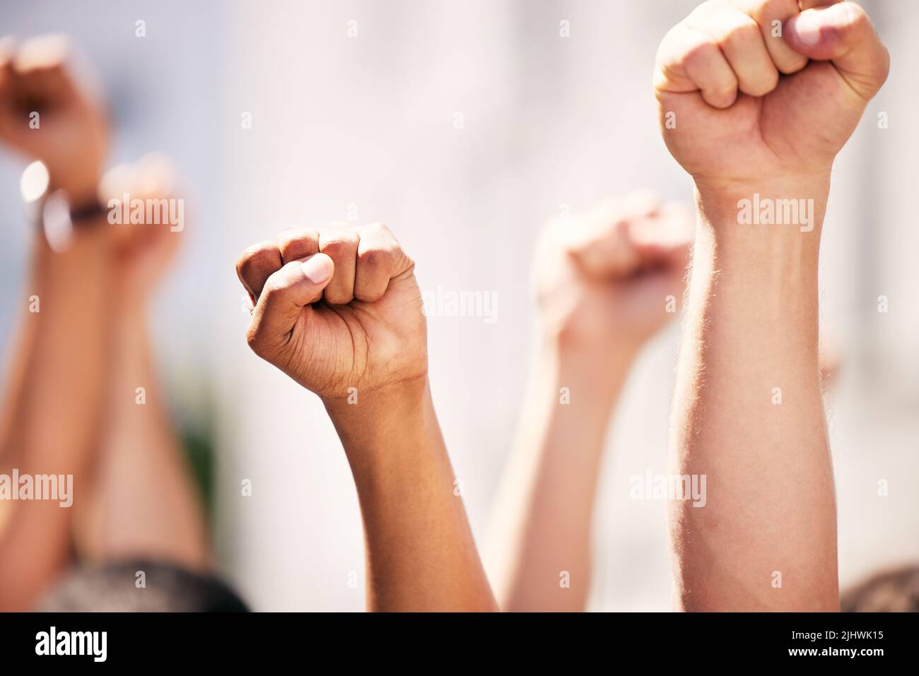 Fighting the dominant power. a group of people with their fists raised ...