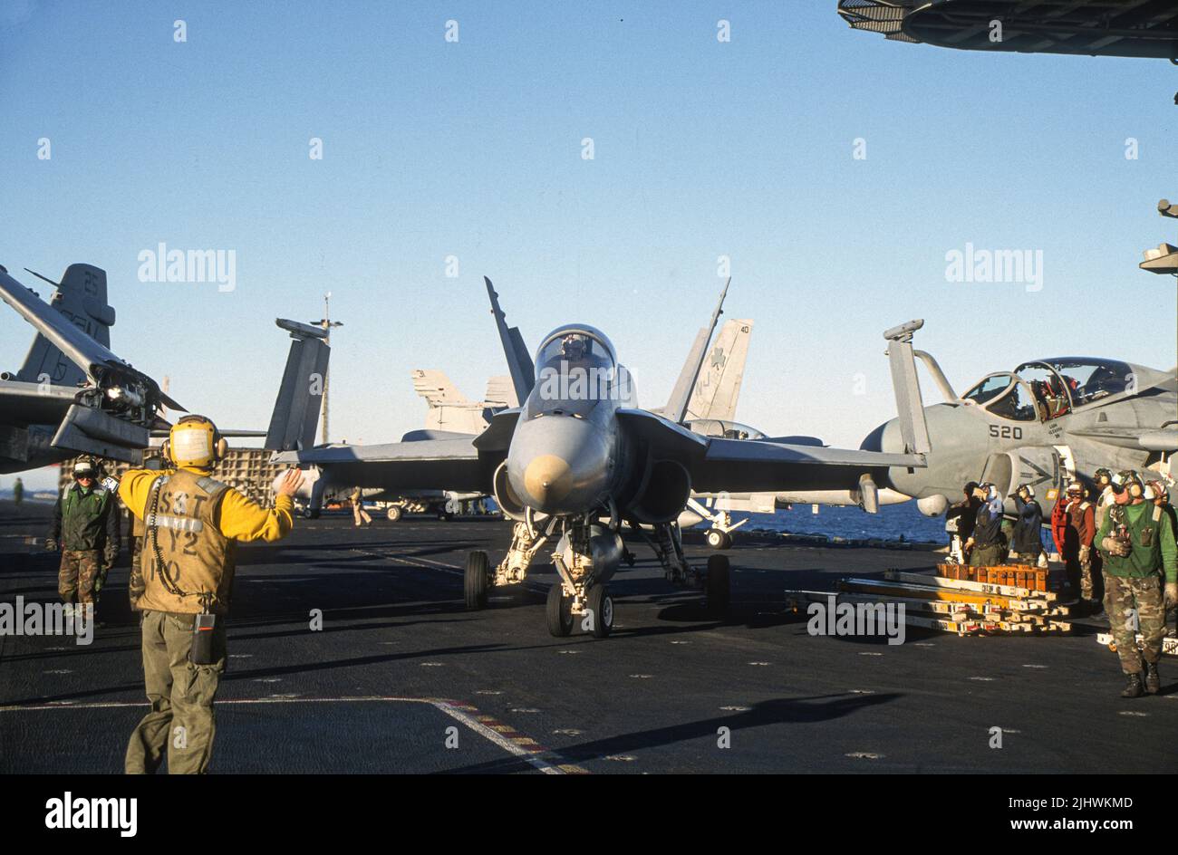 US Navy F/A-18 Hornet maneuvers on deck prior to a catapult launch ...