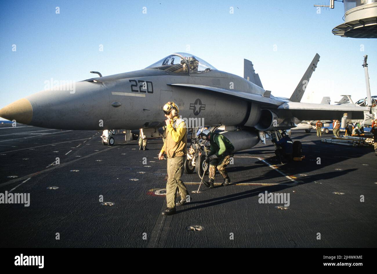 US Navy F/A-18 Hornet maneuvers on deck prior to a catapult launch ...