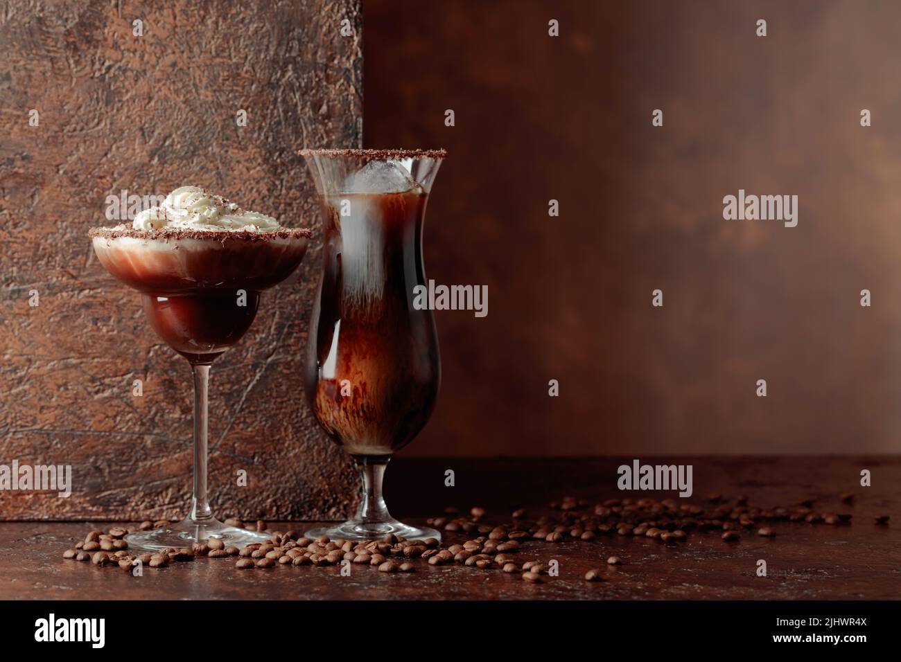 Coffee and chocolate drinks with whipped cream on a brown background ...