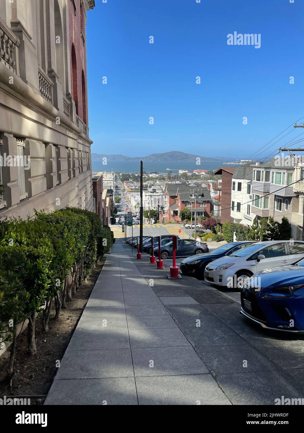 A beautiful view of a street with parked cars and houses Stock Photo ...