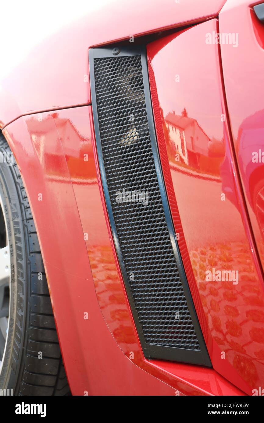 A closeup of a detail of a red luxury car Stock Photo - Alamy