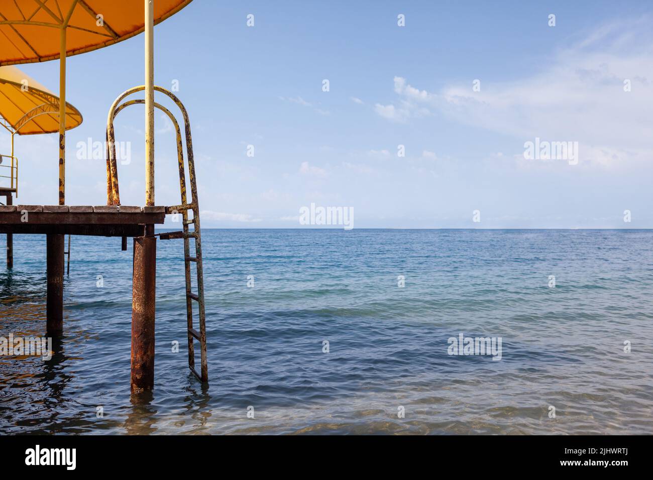 Swimming area or pier on the sea. A large pier with a roof, wooden ...