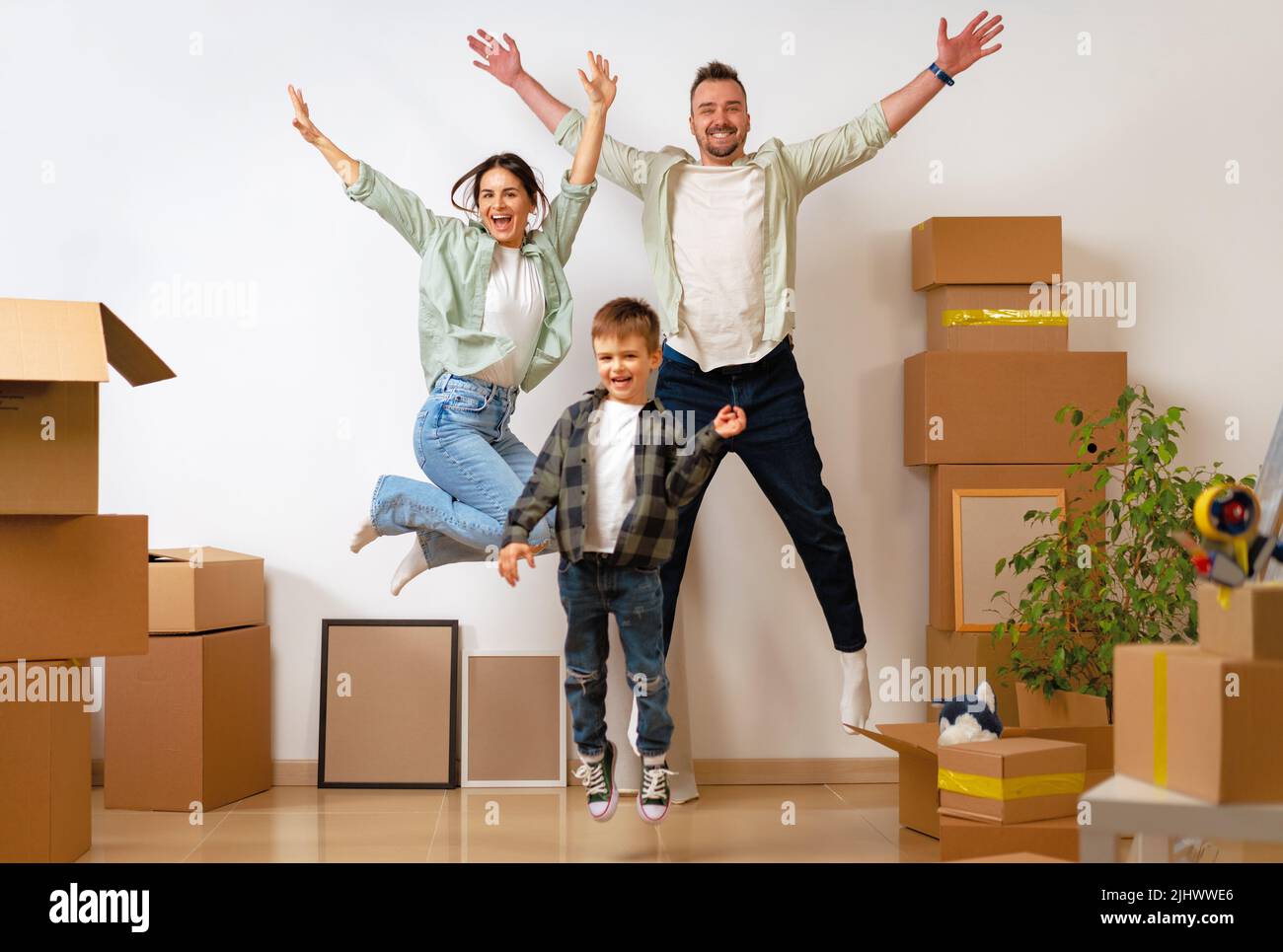Young parents and son having fun during moving day to new house Stock ...
