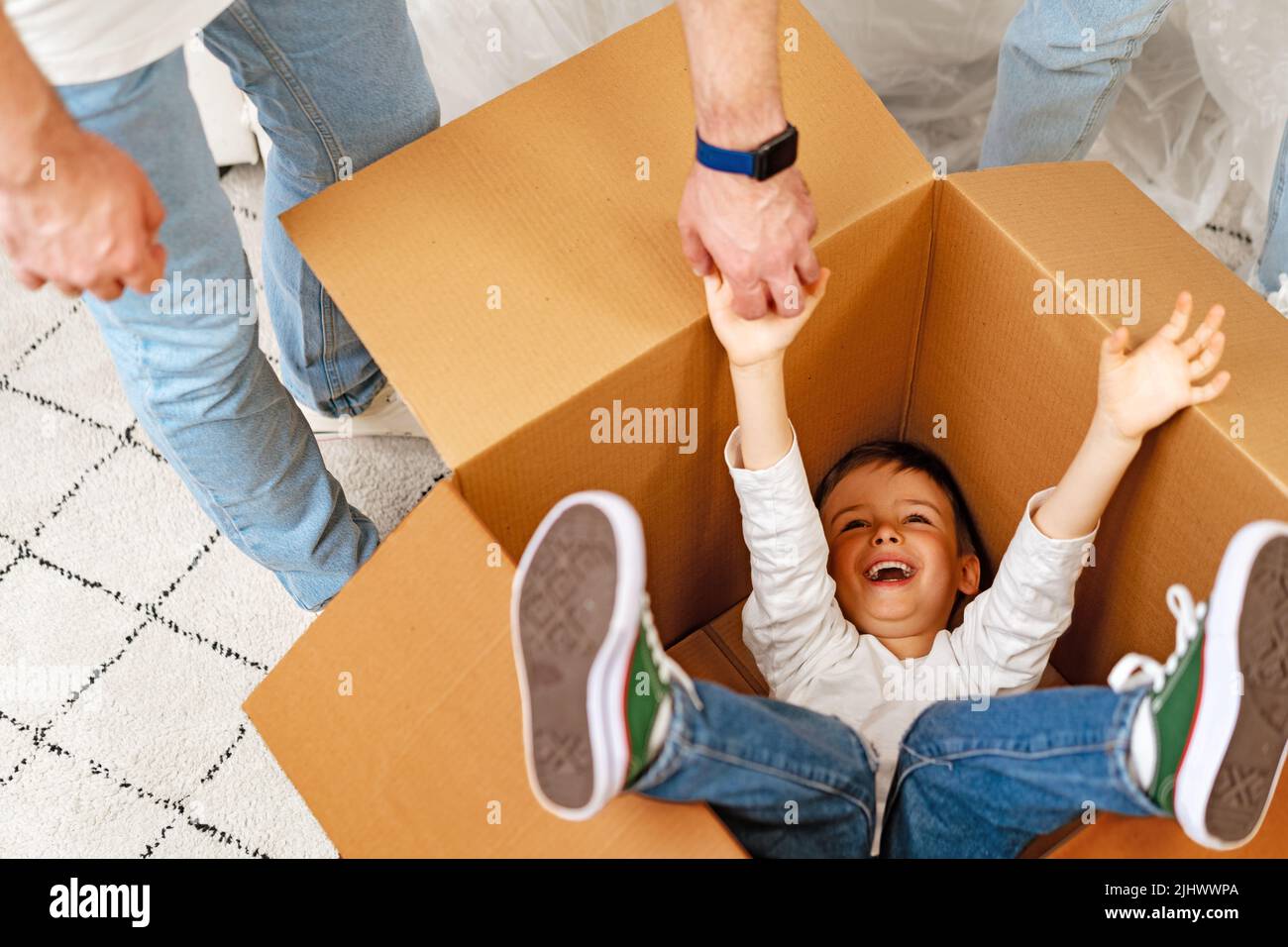 Little boy playing inside a moving box on a moving day Stock Photo - Alamy