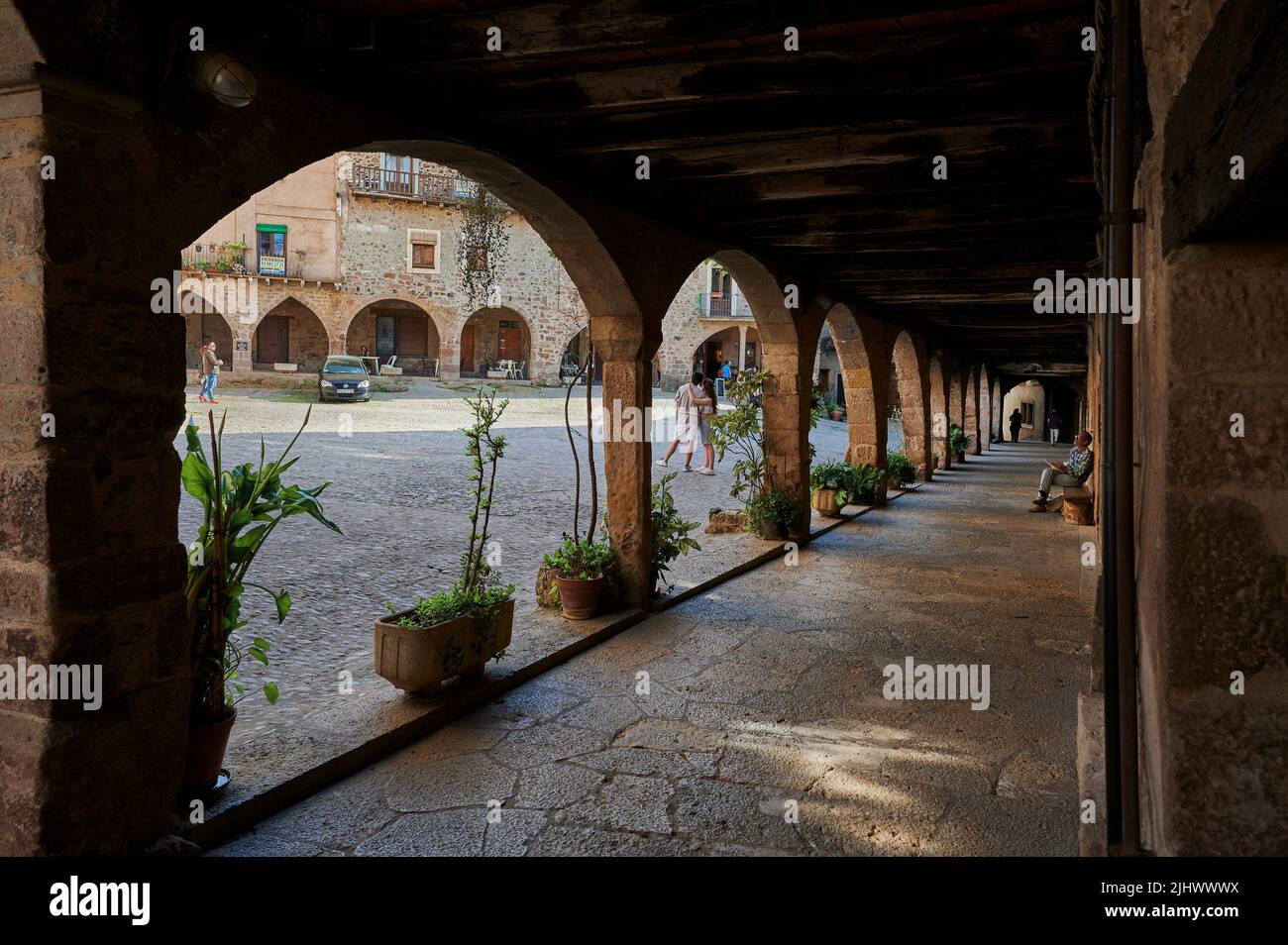 Exterior hall of the main square in the old part of Santa Pau a man ...