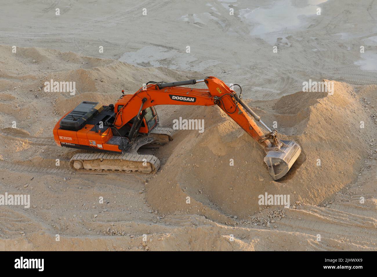 excavator machine at excavation earthmoving work in sand quarry Stock ...