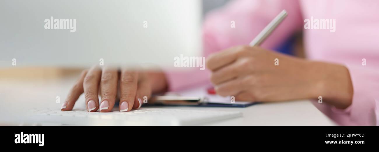 Person writing down ideas in journal on working place, making notes for ...