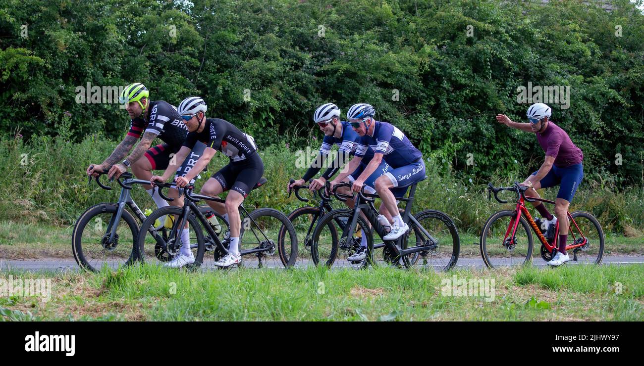 Group of cyclists in lycra and wearing cycling helmets Stock Photo - Alamy
