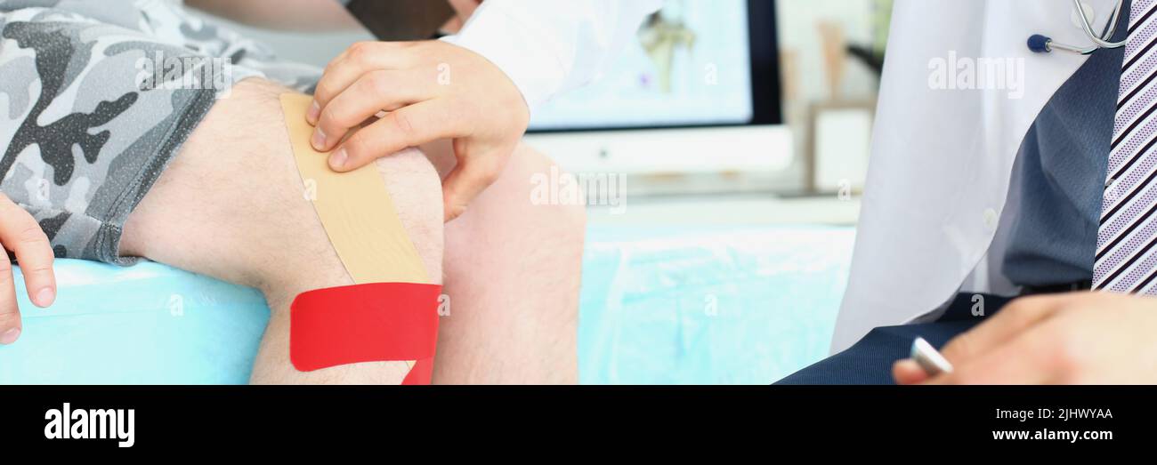 Physician wear uniform and stethoscope carefully examining patient leg ...