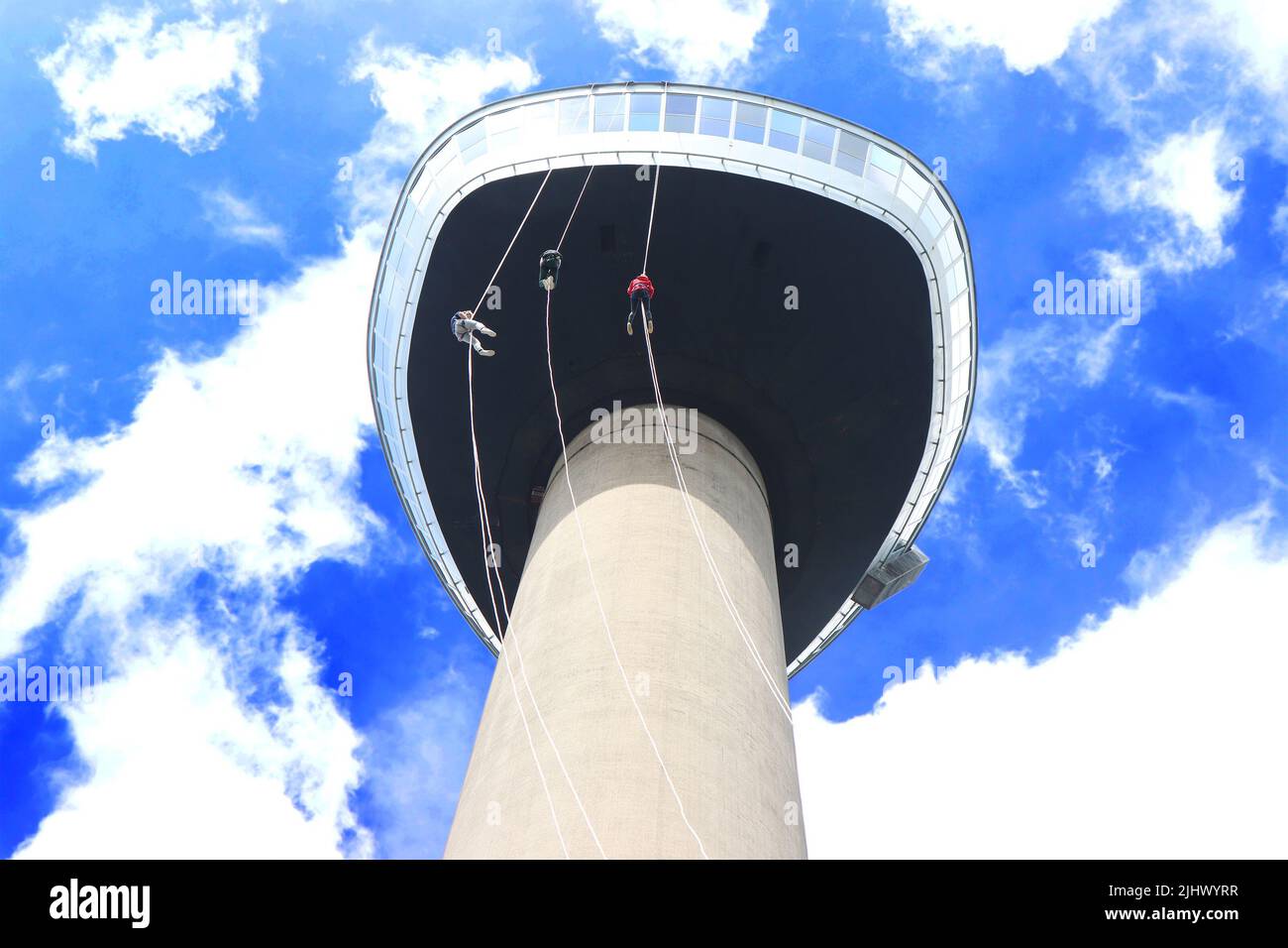 Three young People abseiling down the Euromast tower in Rotterdam Stock ...