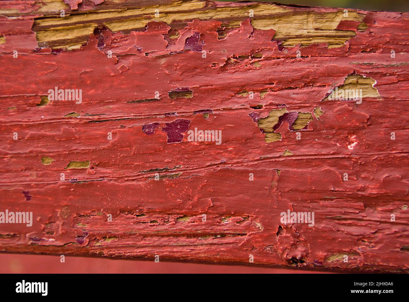 A textured old banister with the red paint chipping off Stock Photo - Alamy