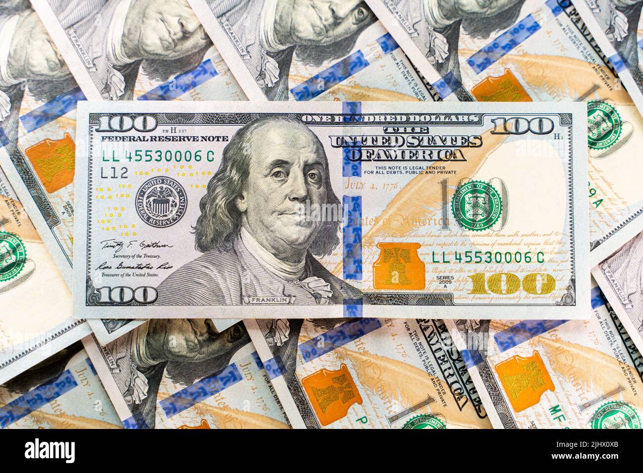 Close-up beautiful clean new one hundred dollar bill lies on other one ...