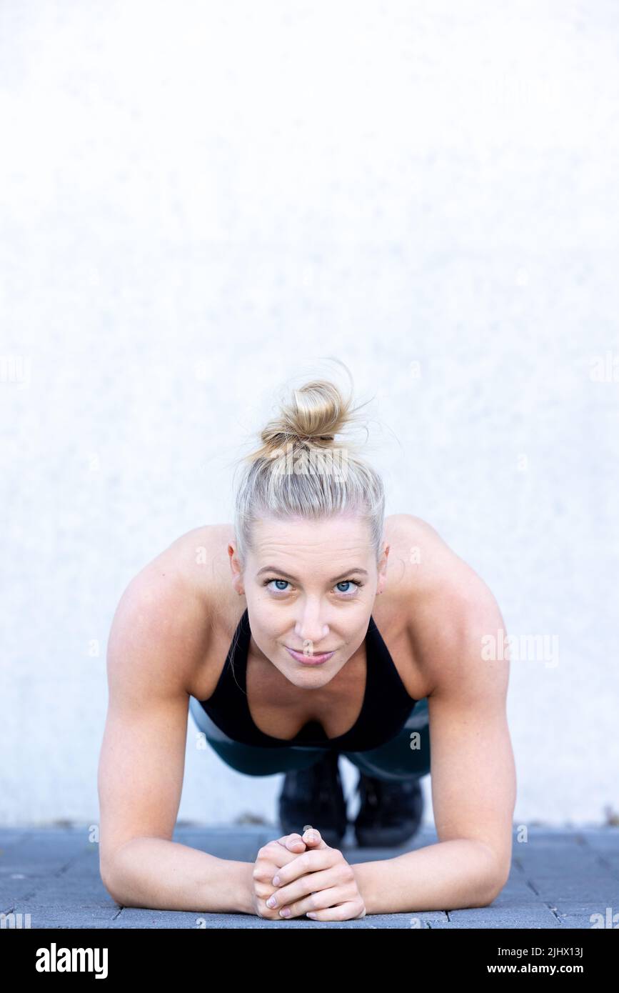 Attractive sporty woman concentrating in gym while doing fitness ...