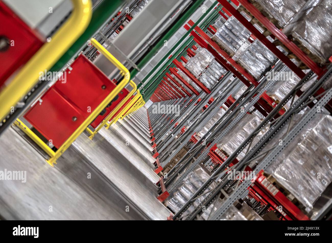 Lifting equipment with cargo near high shelving in storage Stock Photo ...