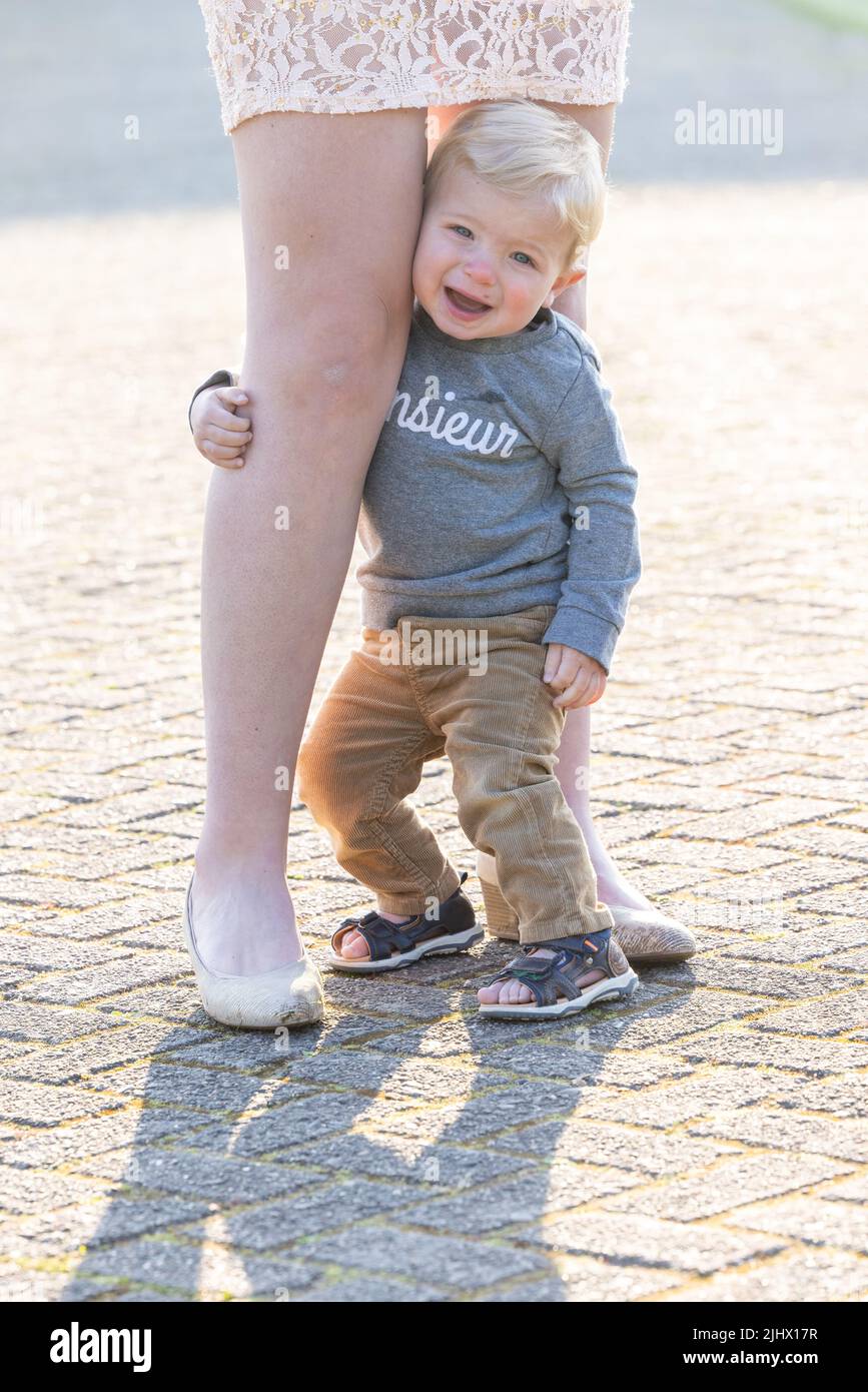 Boy hugs mom leg hi-res stock photography and images - Alamy