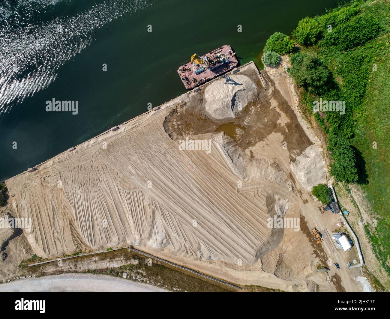 Cargo vessel near river terminal of sand and gravel loading Stock Photo ...