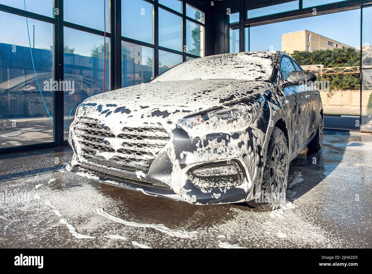The car, doused with foam, is located in the self-service car wash ...