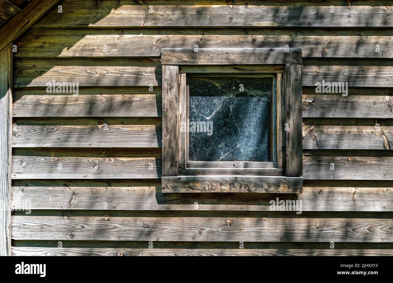 Dirty window in an exterior wall of an old wood building Stock Photo ...