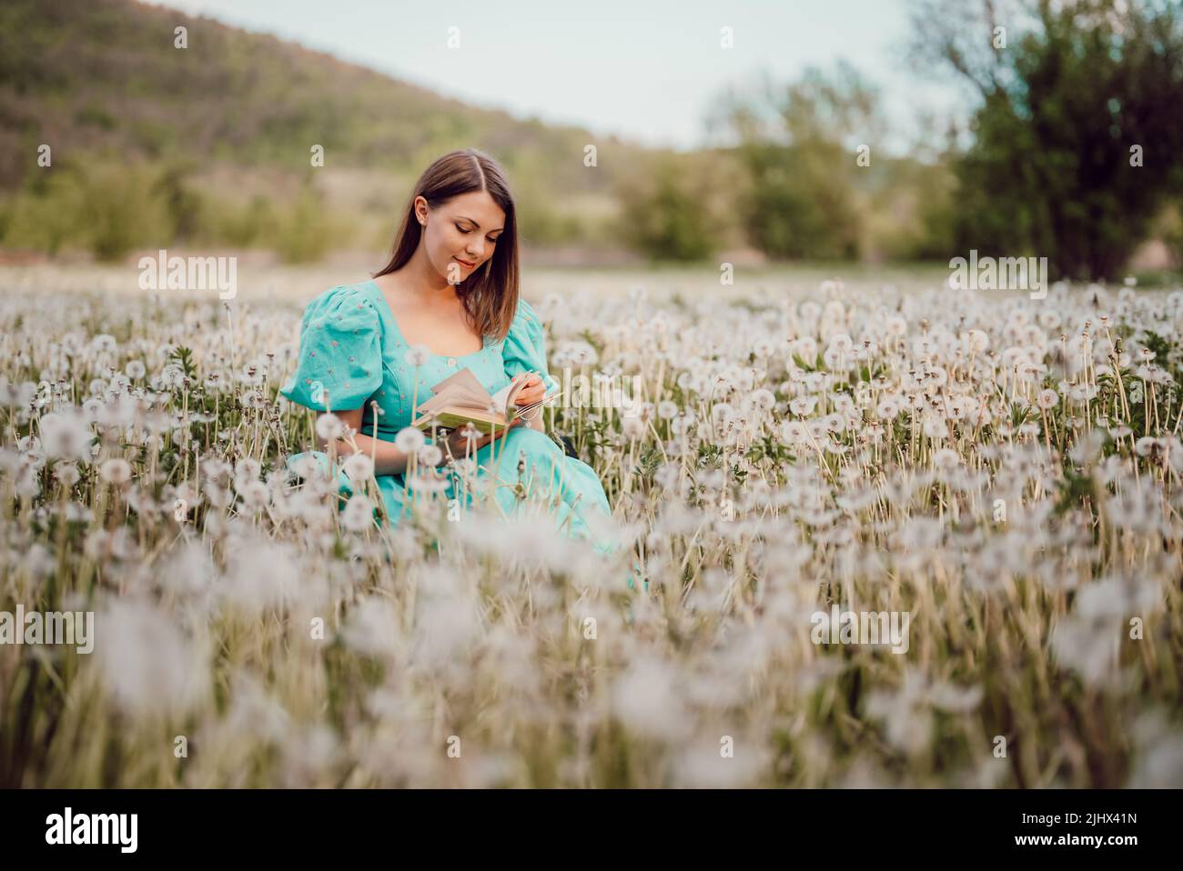 Gorgeous woman reading old paper book. Lady in retro or vintage dress ...