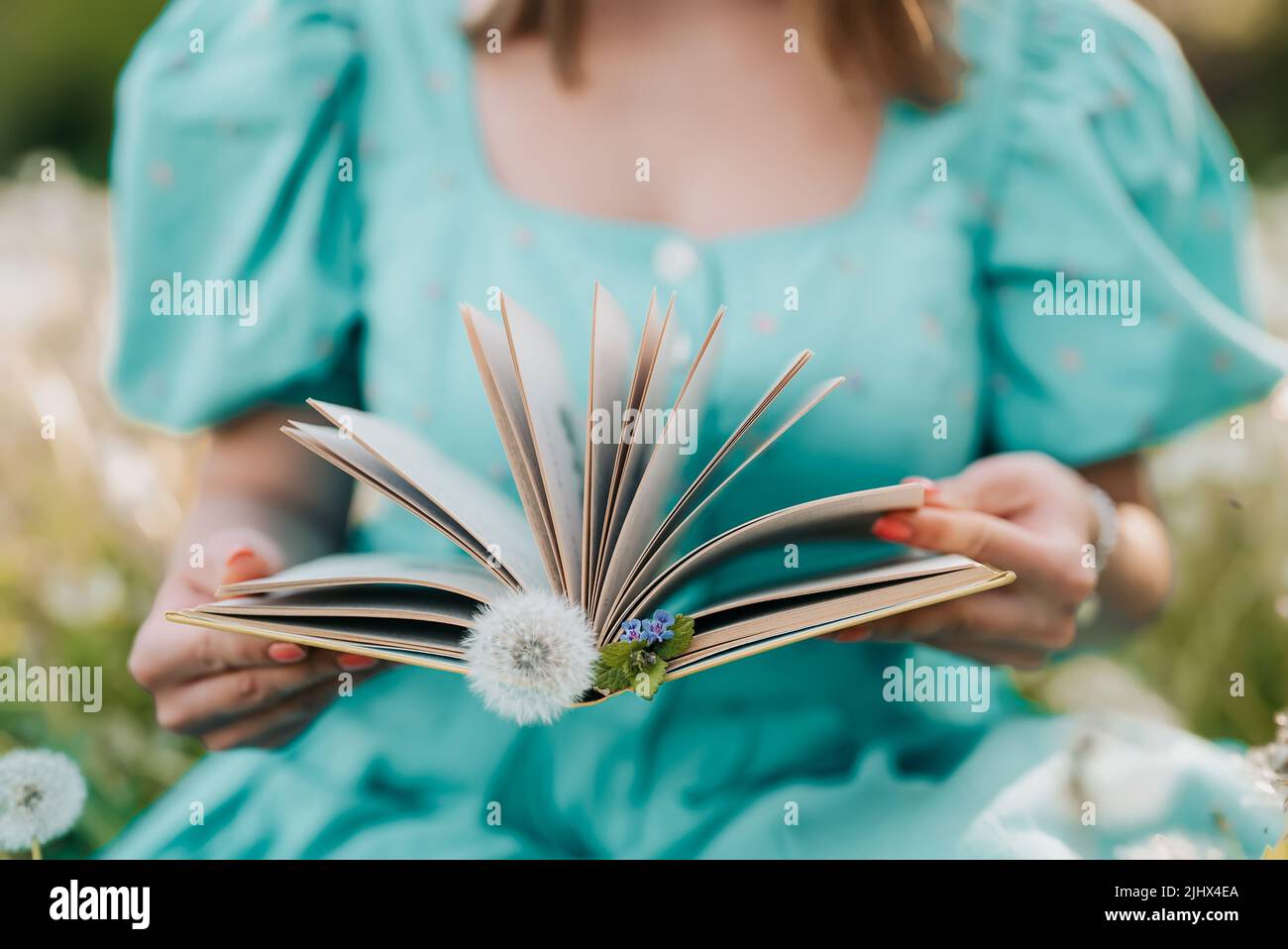 Woman turns over pages of old paper book. Lady in retro or vintage ...
