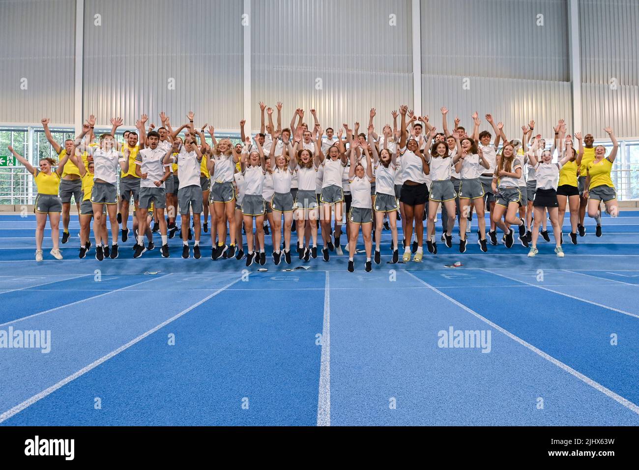 Athletes and staff pose for a family photo at a team building exercise ...