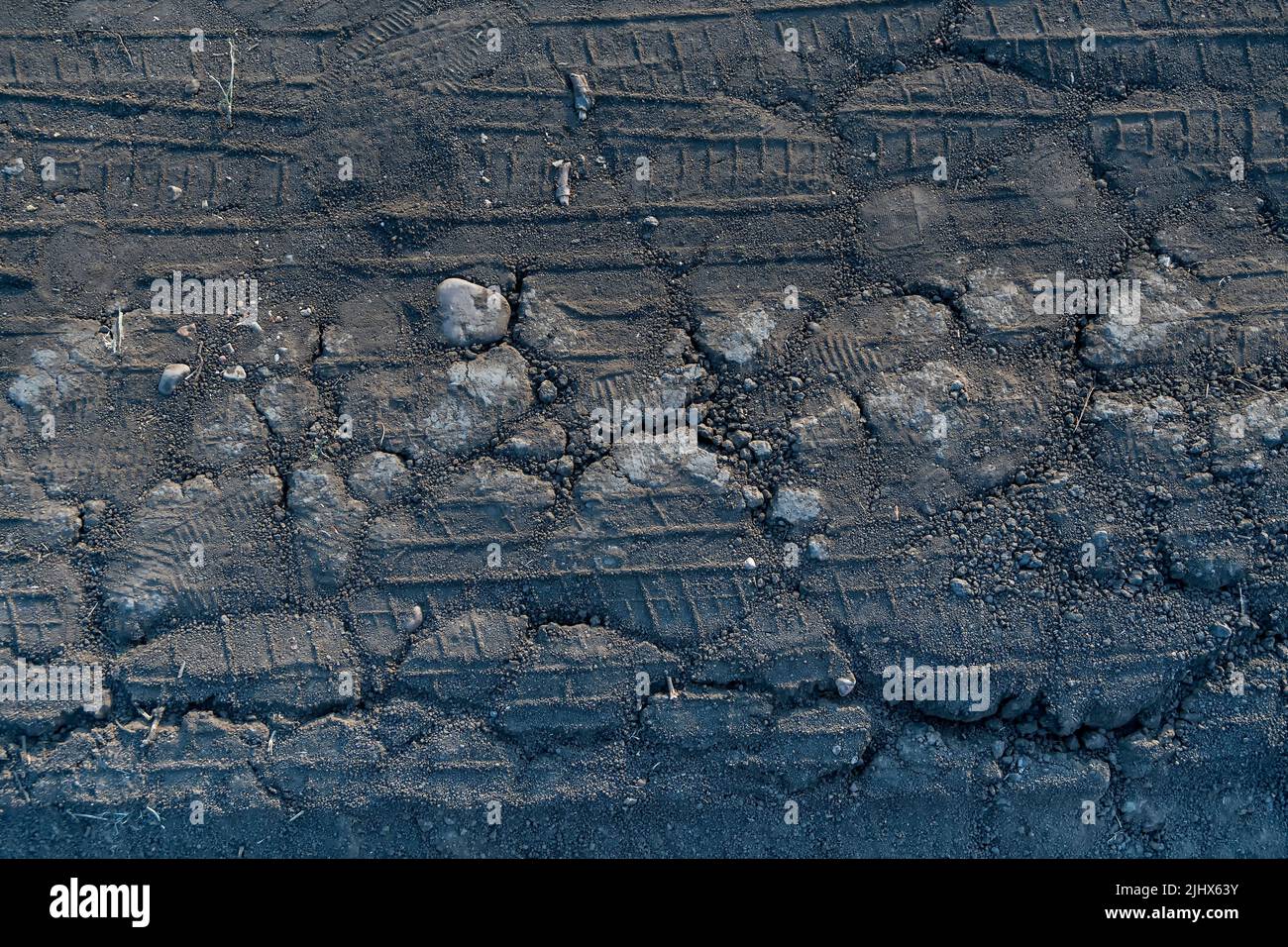 Section of dirt road with cracks in ground from drought and lack of ...