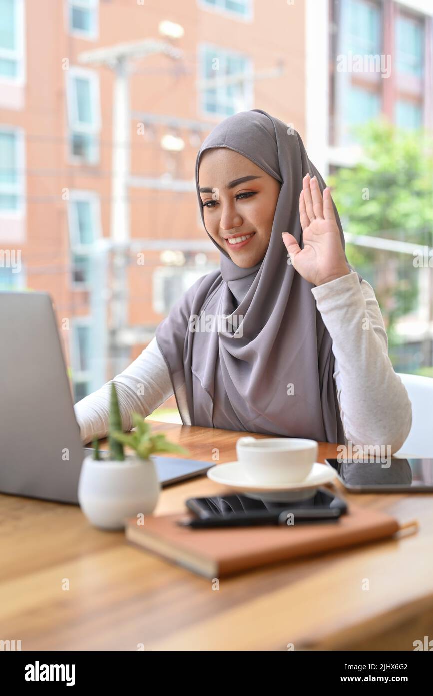 Asian muslim woman communicating by video conference, distance job ...