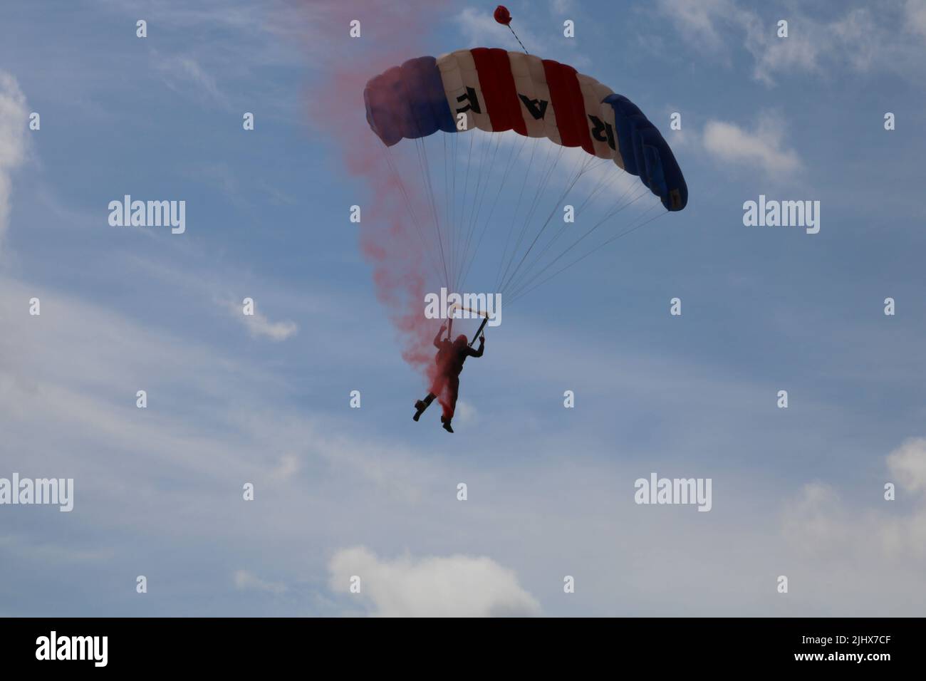 A closeup of a man flying with a parachute during National Armed Forces ...