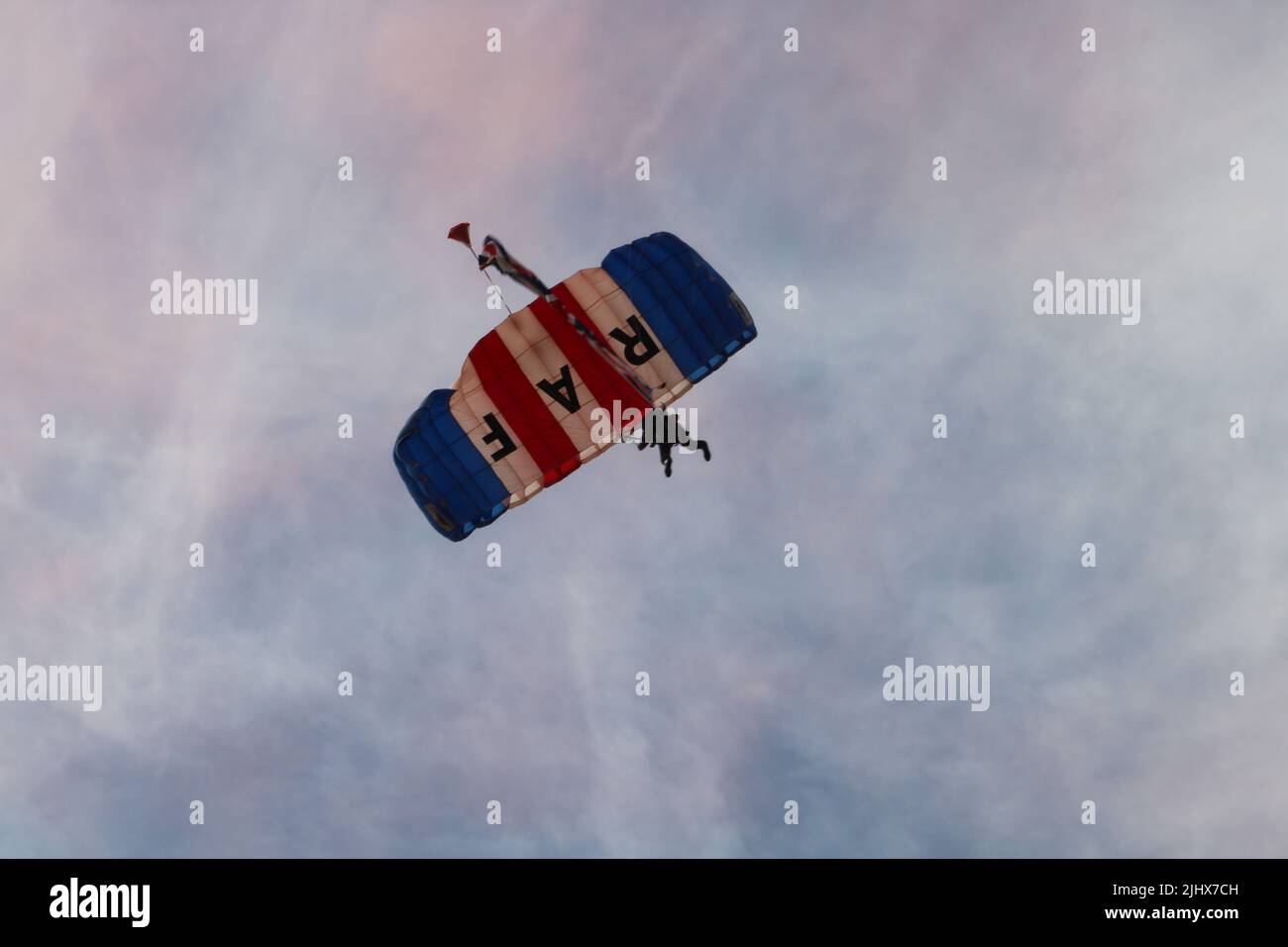 A closeup of a man flying with a parachute during National Armed Forces ...