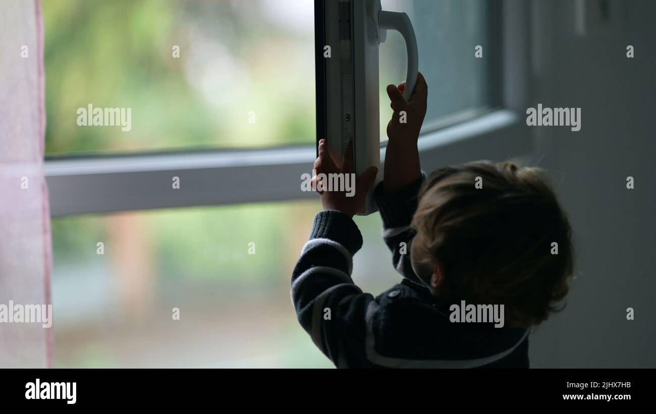Little boy opening home window letting fresh air enter Stock Photo - Alamy