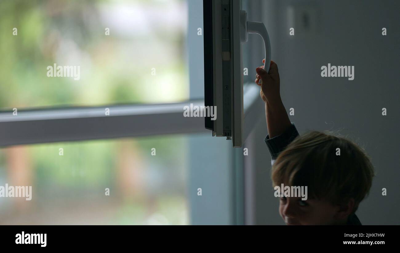 Little boy opening home window letting fresh air enter Stock Photo - Alamy