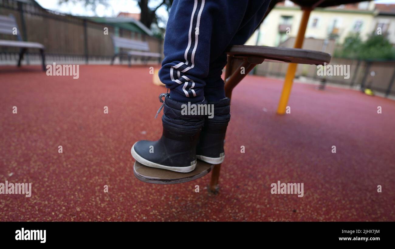 Little boy stepping down from playground structure steps equipment ...