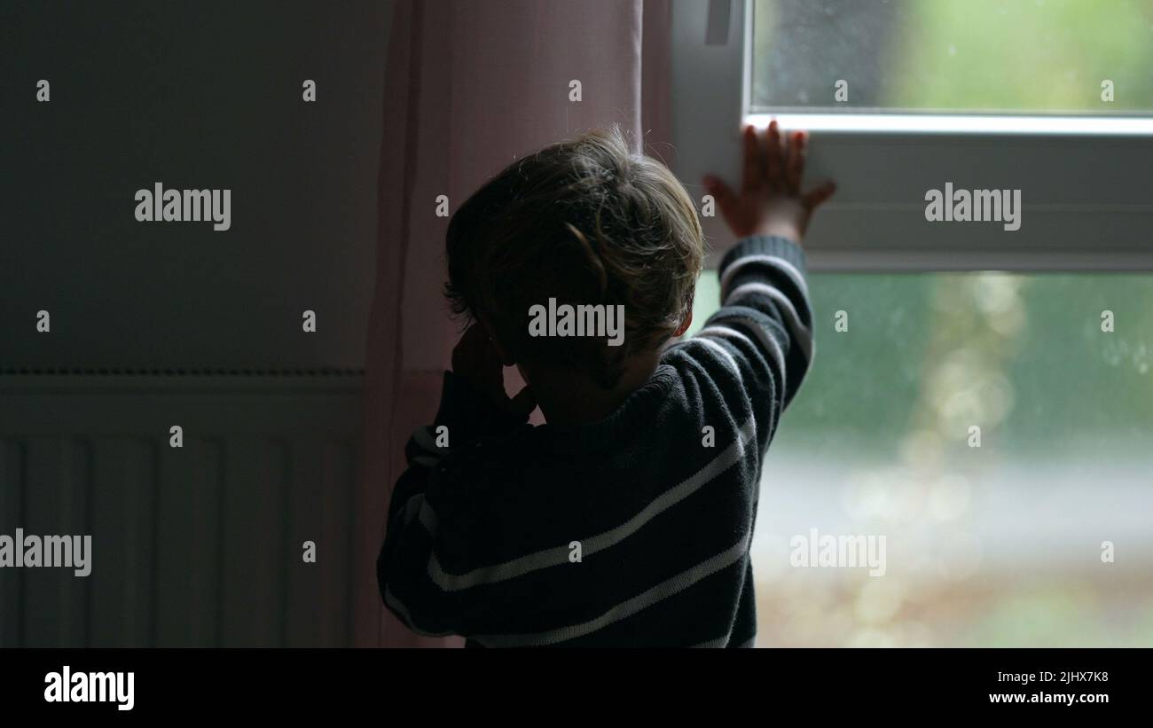 Little boy shutting window home. Child closes window Stock Photo - Alamy