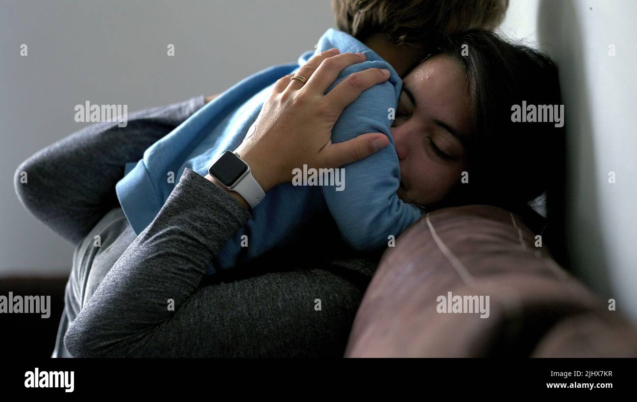 Mother and child authentic love and affection moment, son embracing mom ...