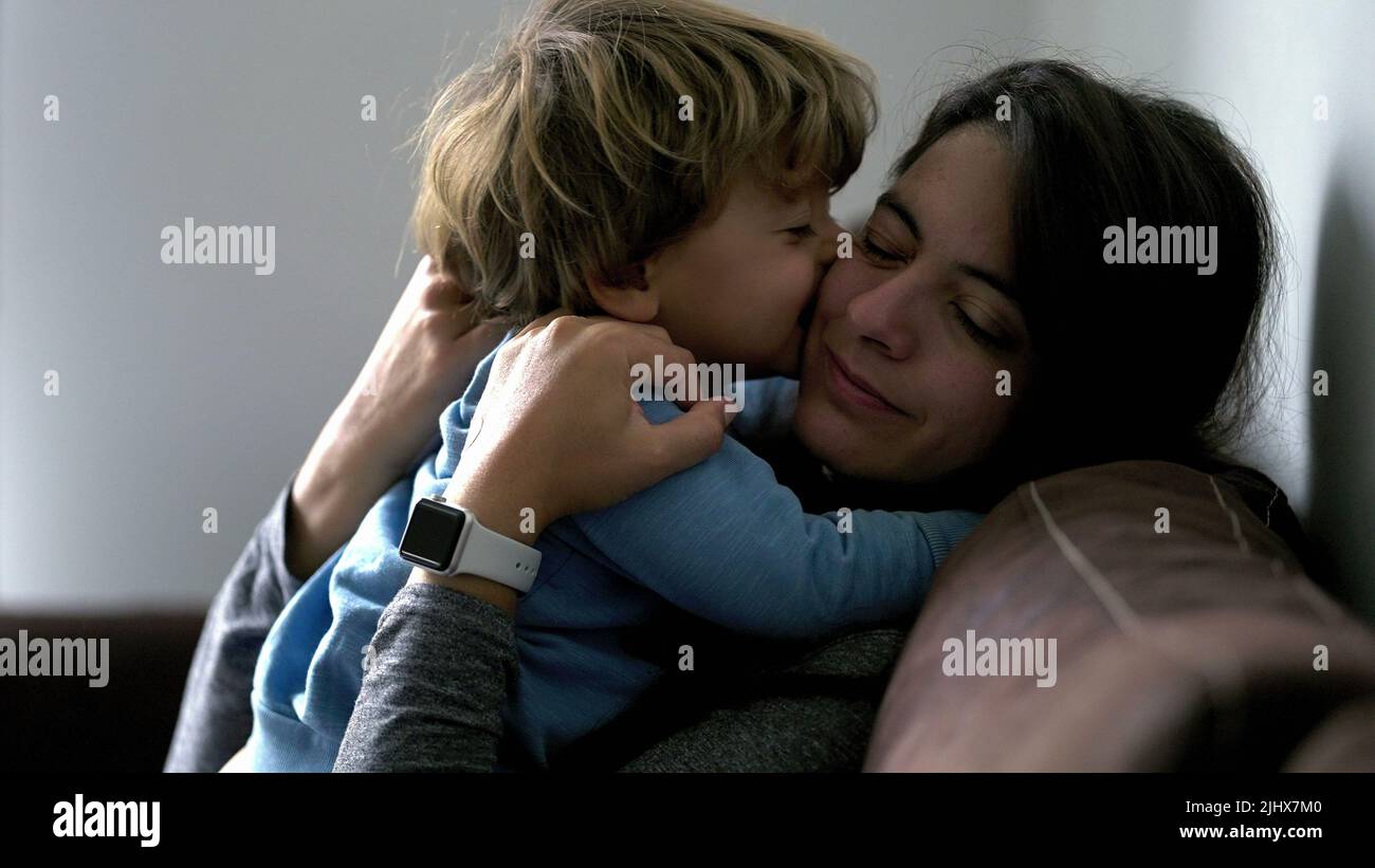 Mother and child authentic love and affection moment, son embracing mom ...