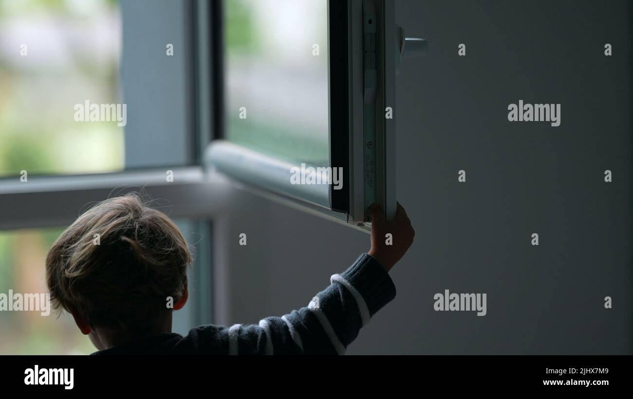 Child closing window. Toddler closes window Stock Photo - Alamy