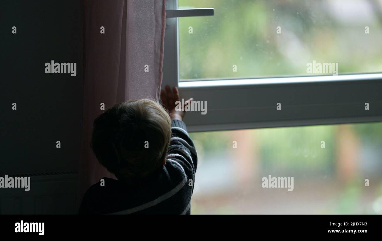 Child closing window. Toddler closes window Stock Photo - Alamy