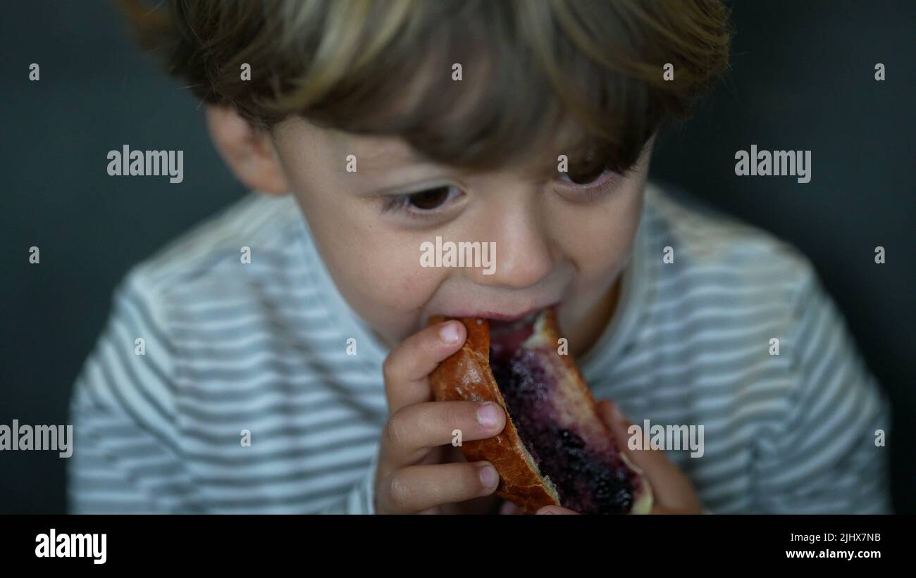 Child eating morning bread with jelly for breakfast Stock Photo - Alamy