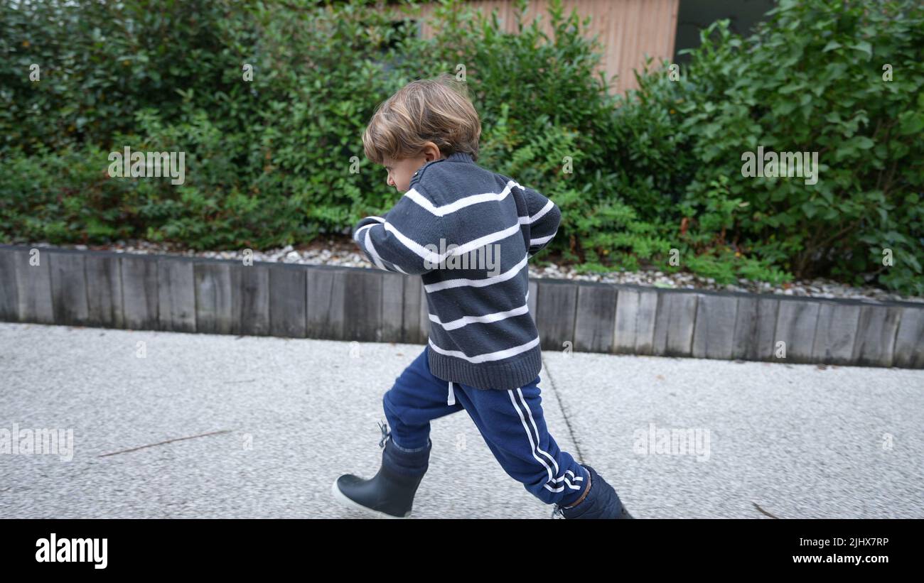 Happy child running outside in slow-motion. Joyful toddler runs Stock ...